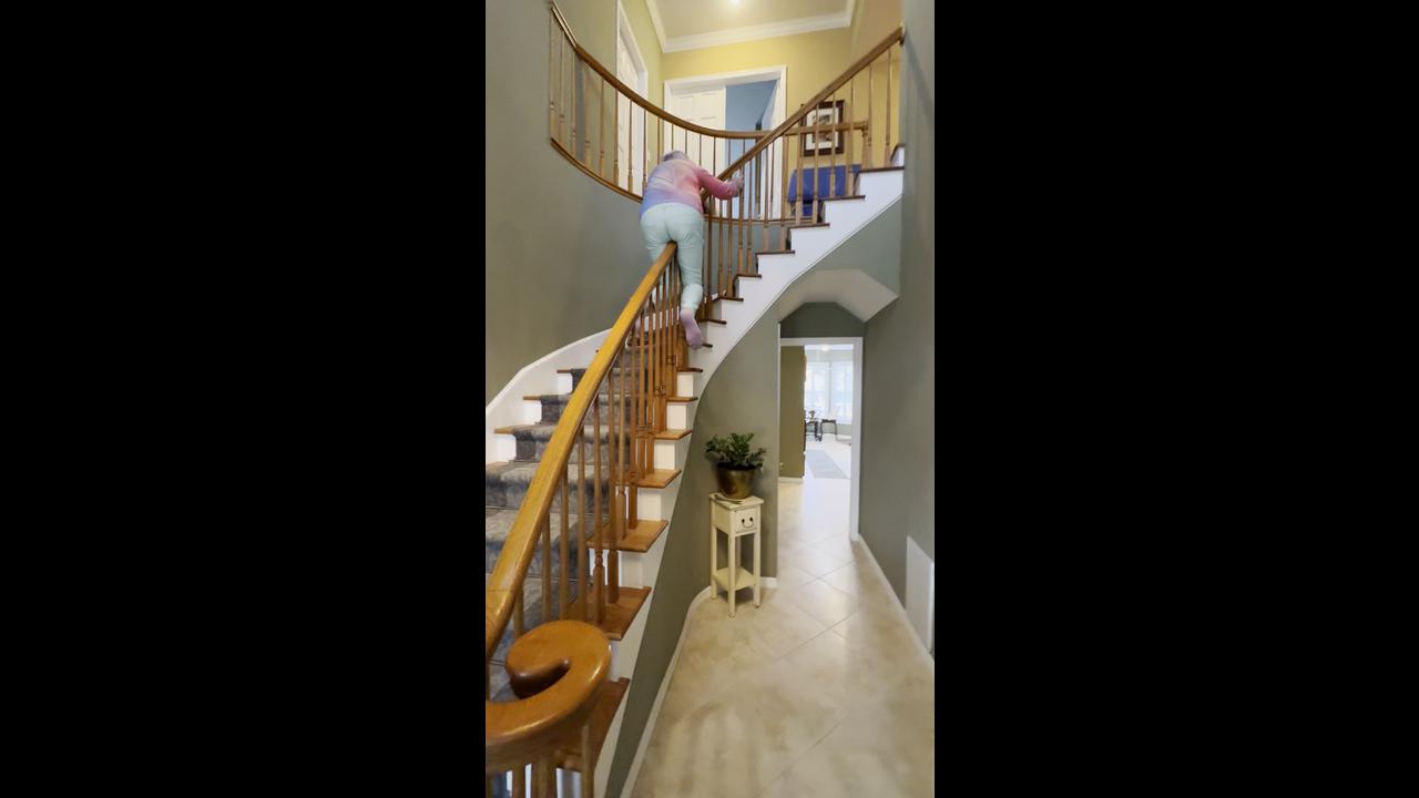 Playful Nan Slides Backward Down Banister