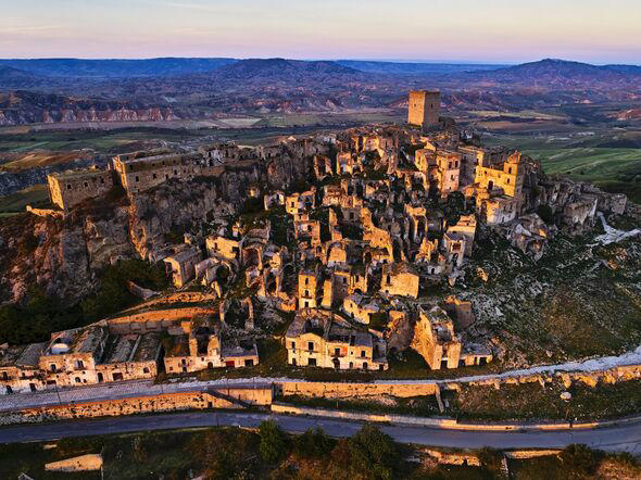 The abandoned Italian 'ghost town' carved into a rock that's a haven ...