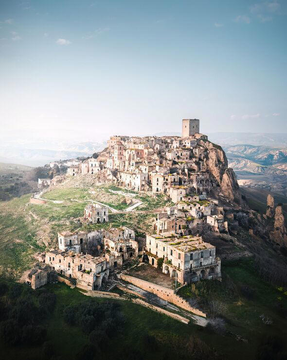 The abandoned Italian 'ghost town' carved into a rock that's a haven ...