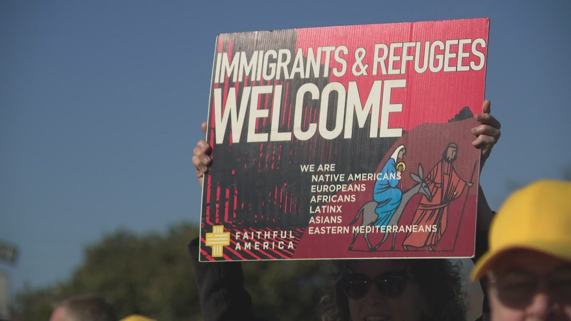 Protestors raise their voices, signs in support of undocumented ...