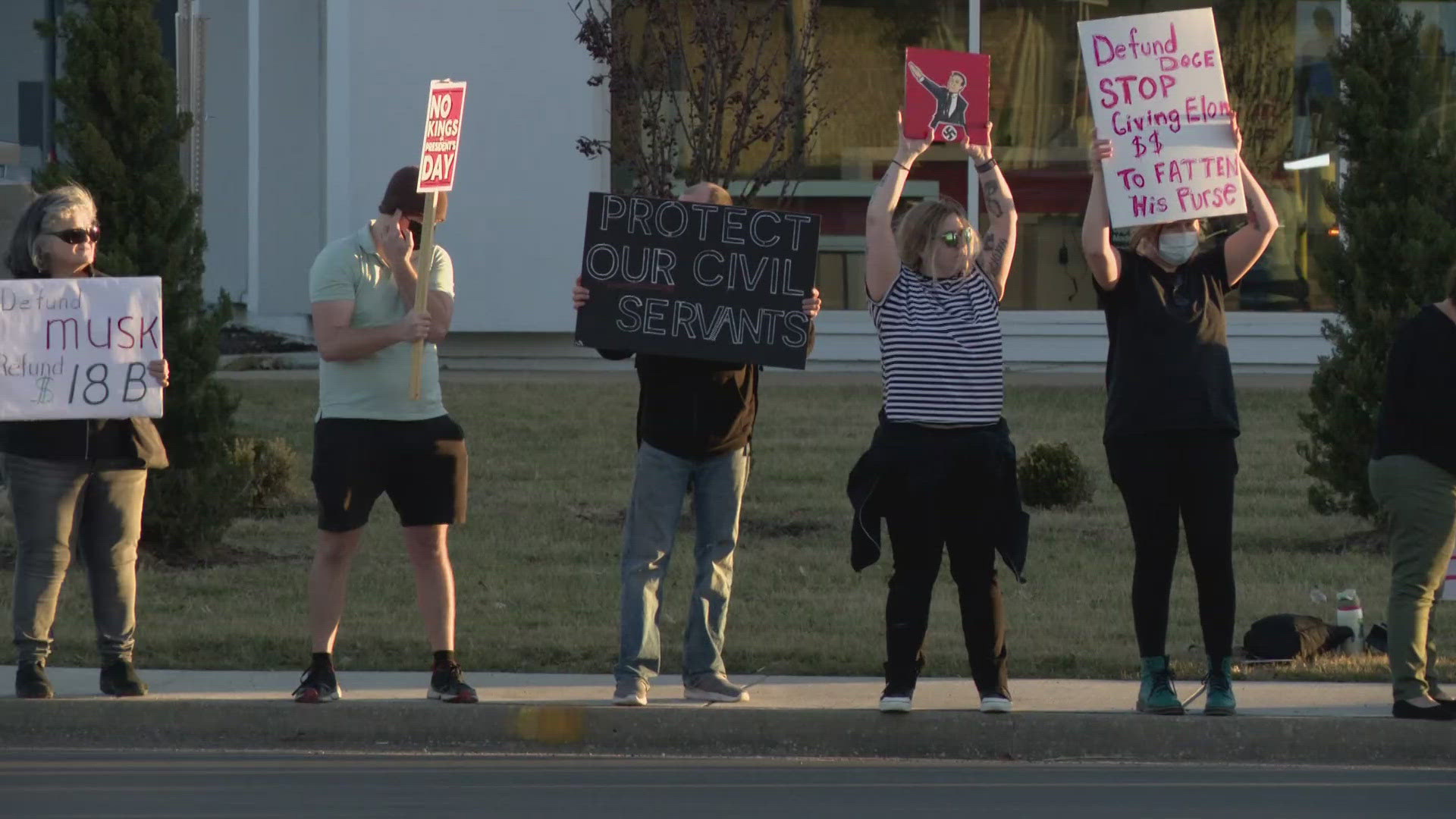 St. Louisans protest DOGE layoffs, cuts at Tesla dealership
