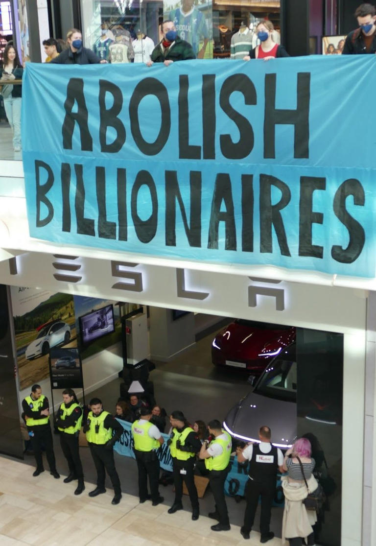 Climate change protesters occupy Tesla showroom in Britain's largest ...