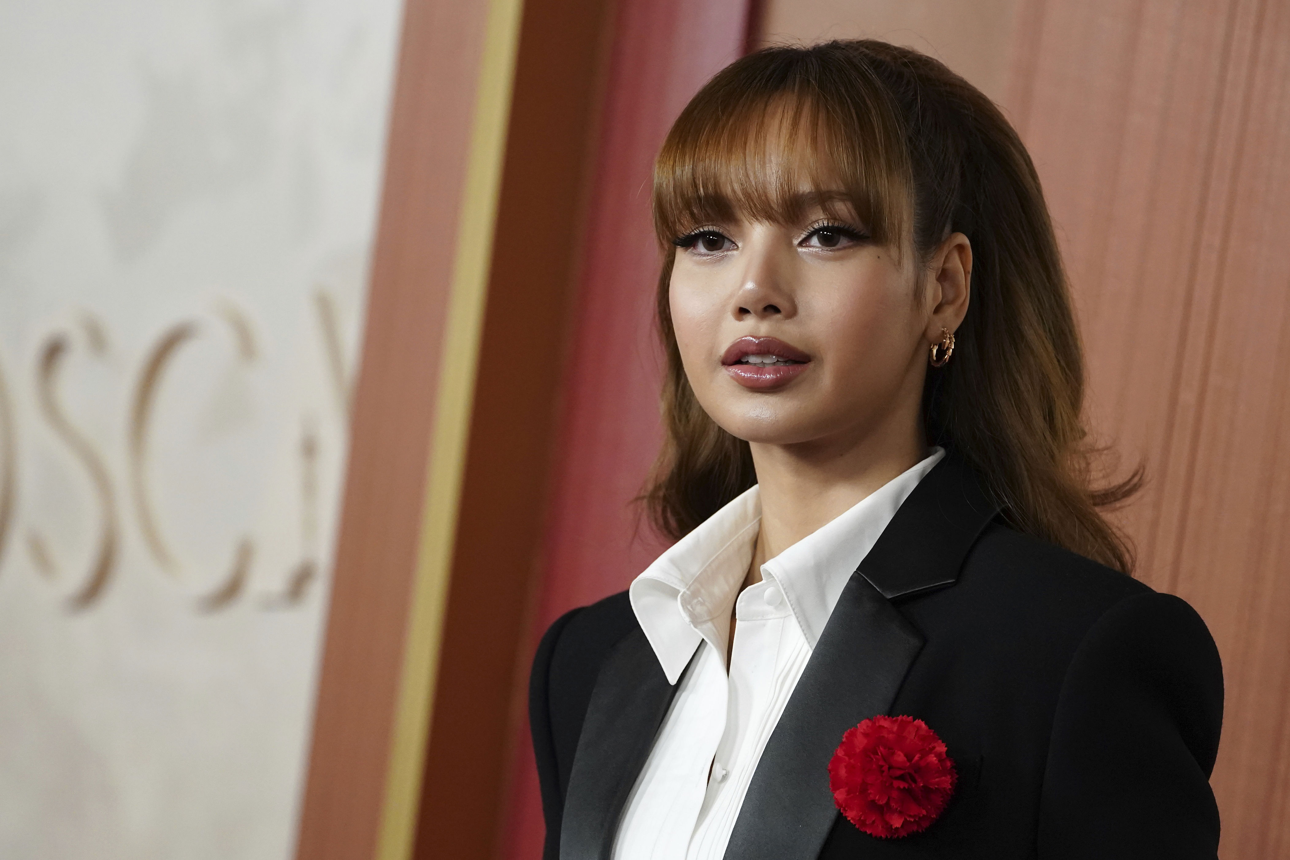 ‘White Lotus’ star Lisa suits up for Oscars 2025 red carpet