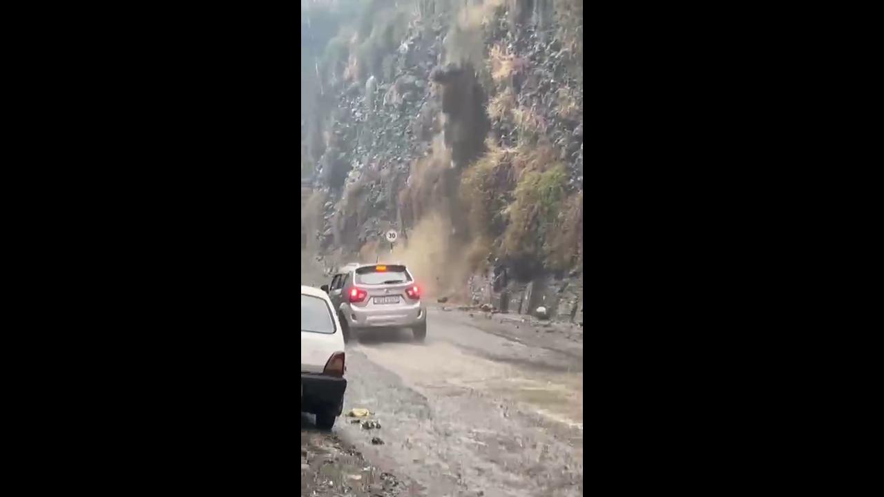 Driver hits the brakes as landslide crashes down mountainside
