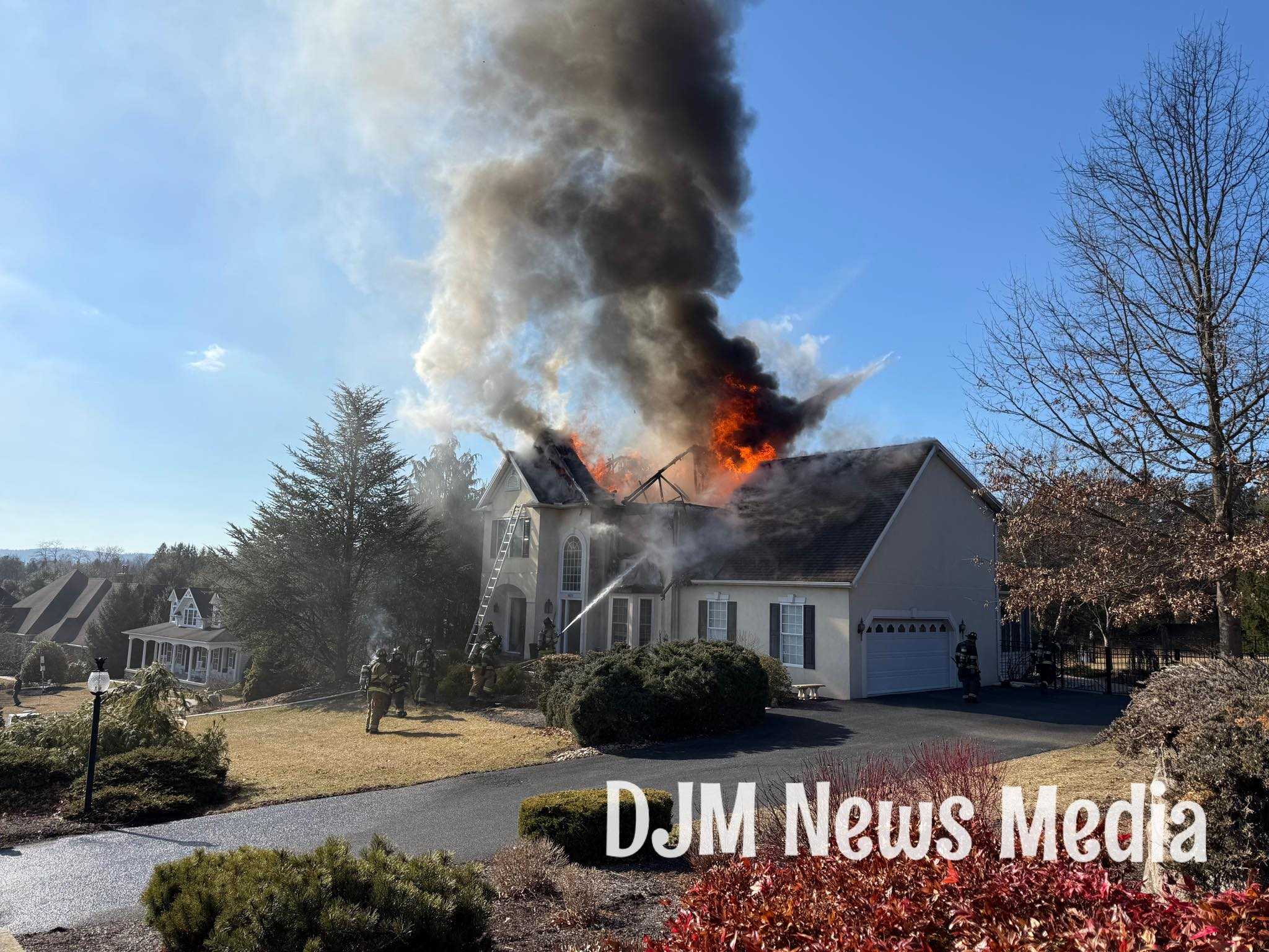 Heavy flames, thick smoke billow from 2-alarm house fire