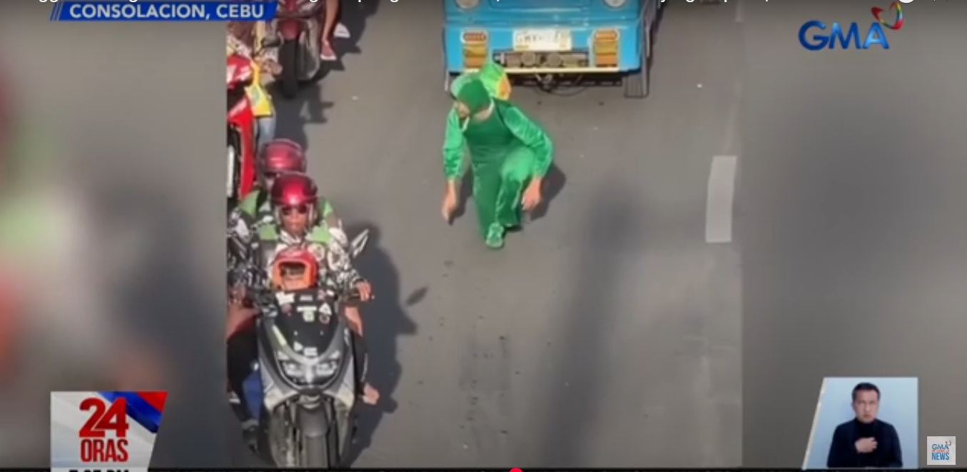 Vlogger disrupts Cebu traffic by crawling in snail costume