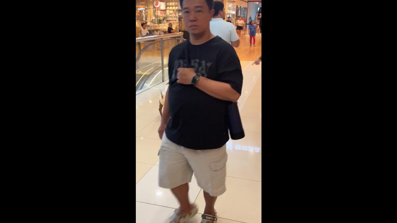 Family take pet goat for a walk through shopping mall