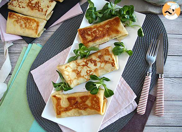 Stuffed crepes with béchamel sauce, cheese, and ham