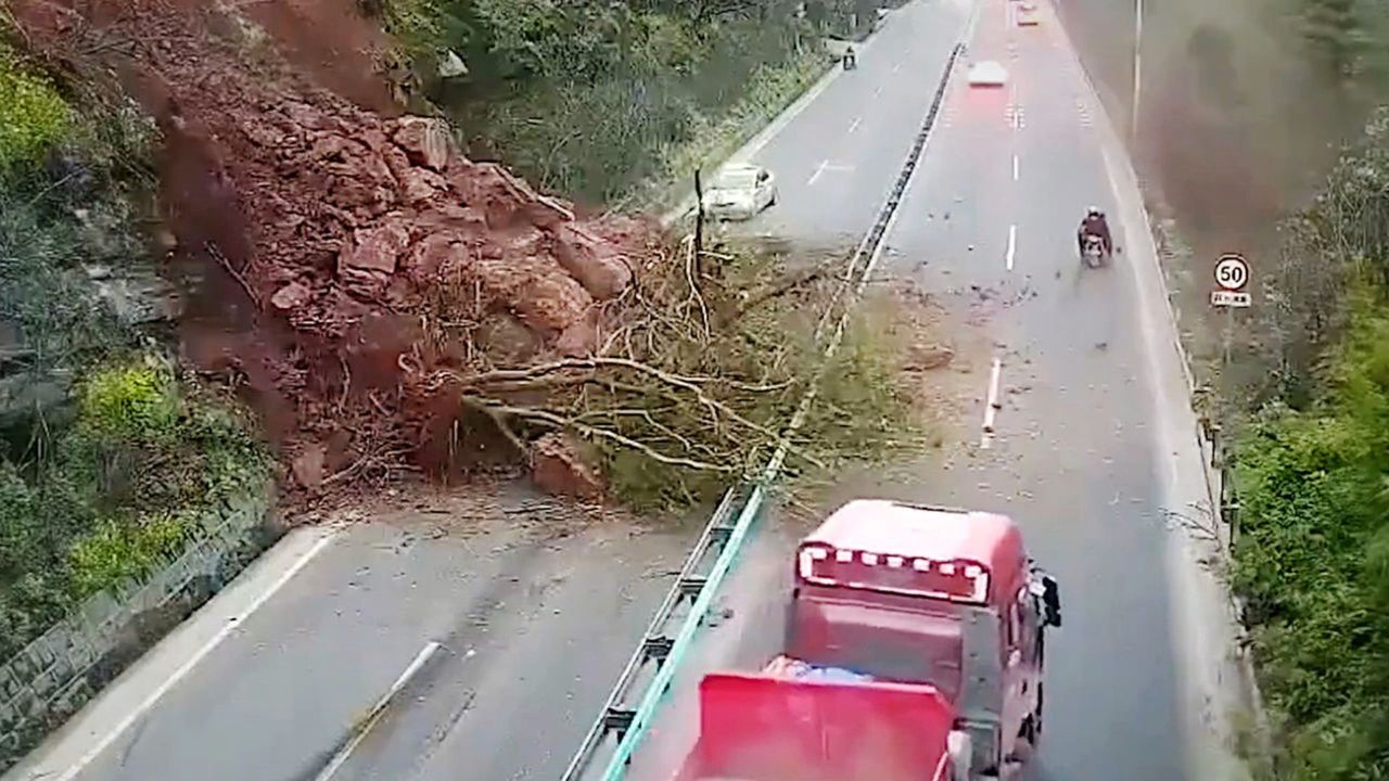 Lucky drivers escape huge landslide crashing down hill in China