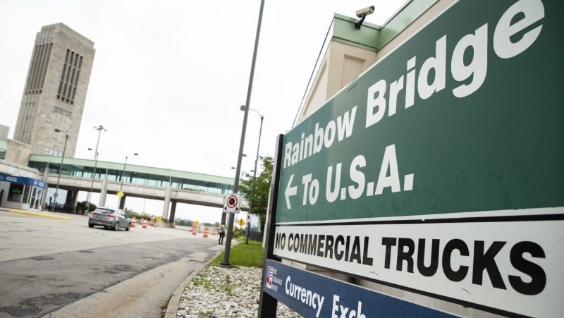 Two in custody after man found hidden under luggage at Rainbow Bridge