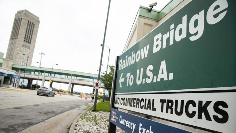 Two in custody after man found hidden under luggage at Rainbow Bridge