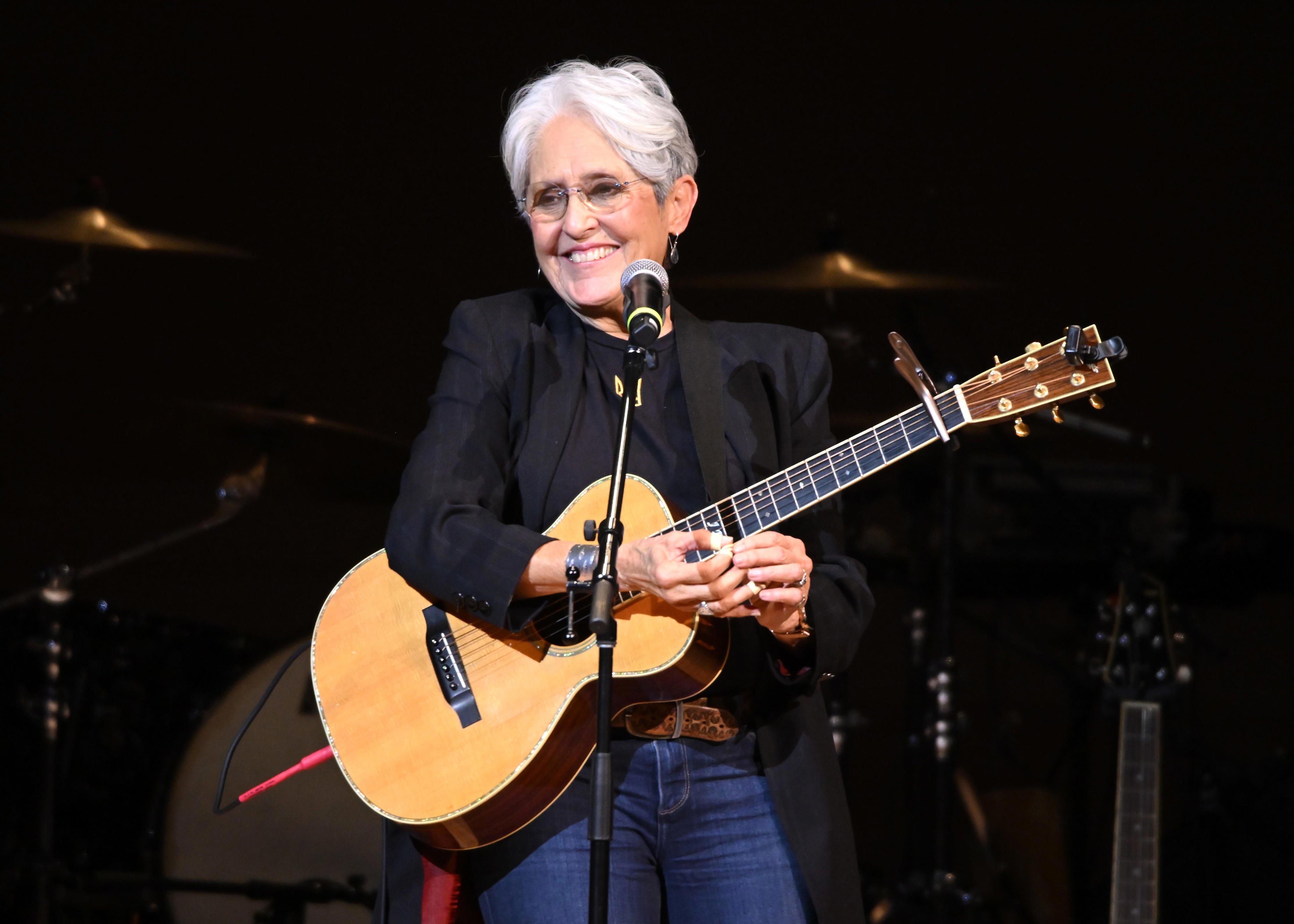 Joan Baez stops by John Mulaney's live Netflix show to blast ...