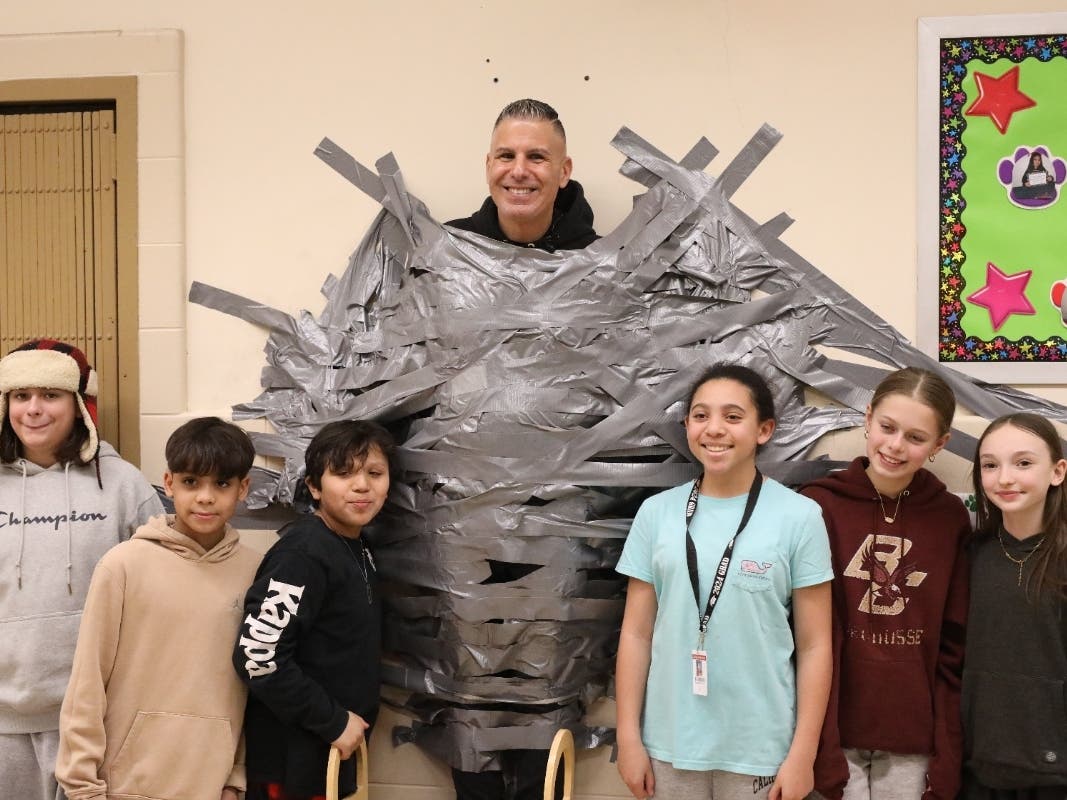Silas Wood Principal Duct Taped To The Wall