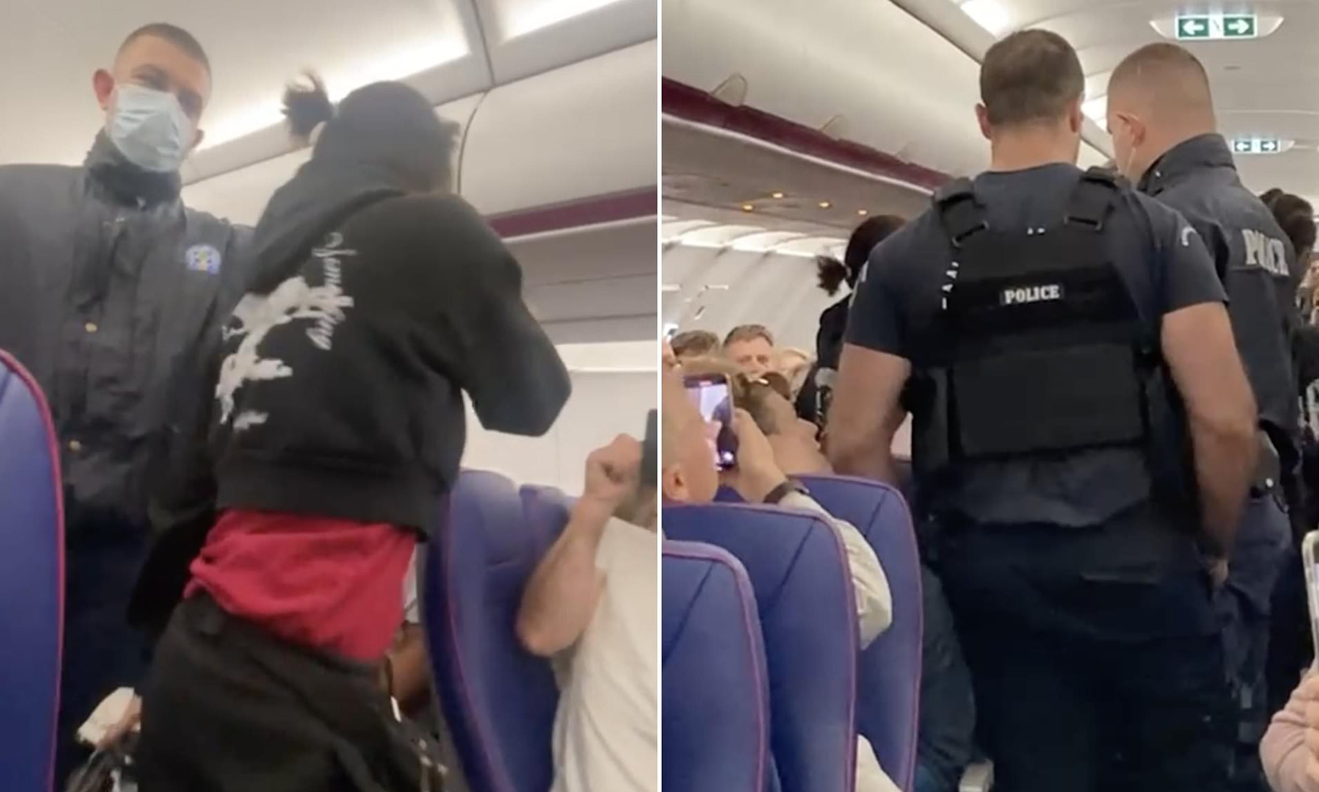 Moment woman who forced flight to divert is removed from plane