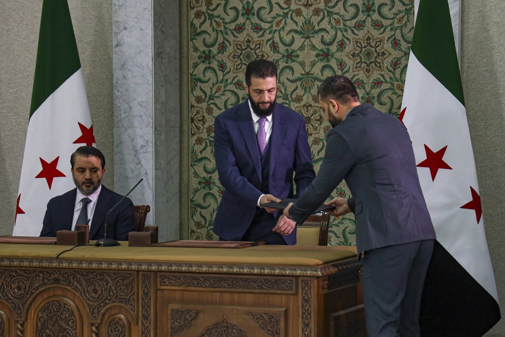 Syrian leader signs constitution that puts the country under an ...