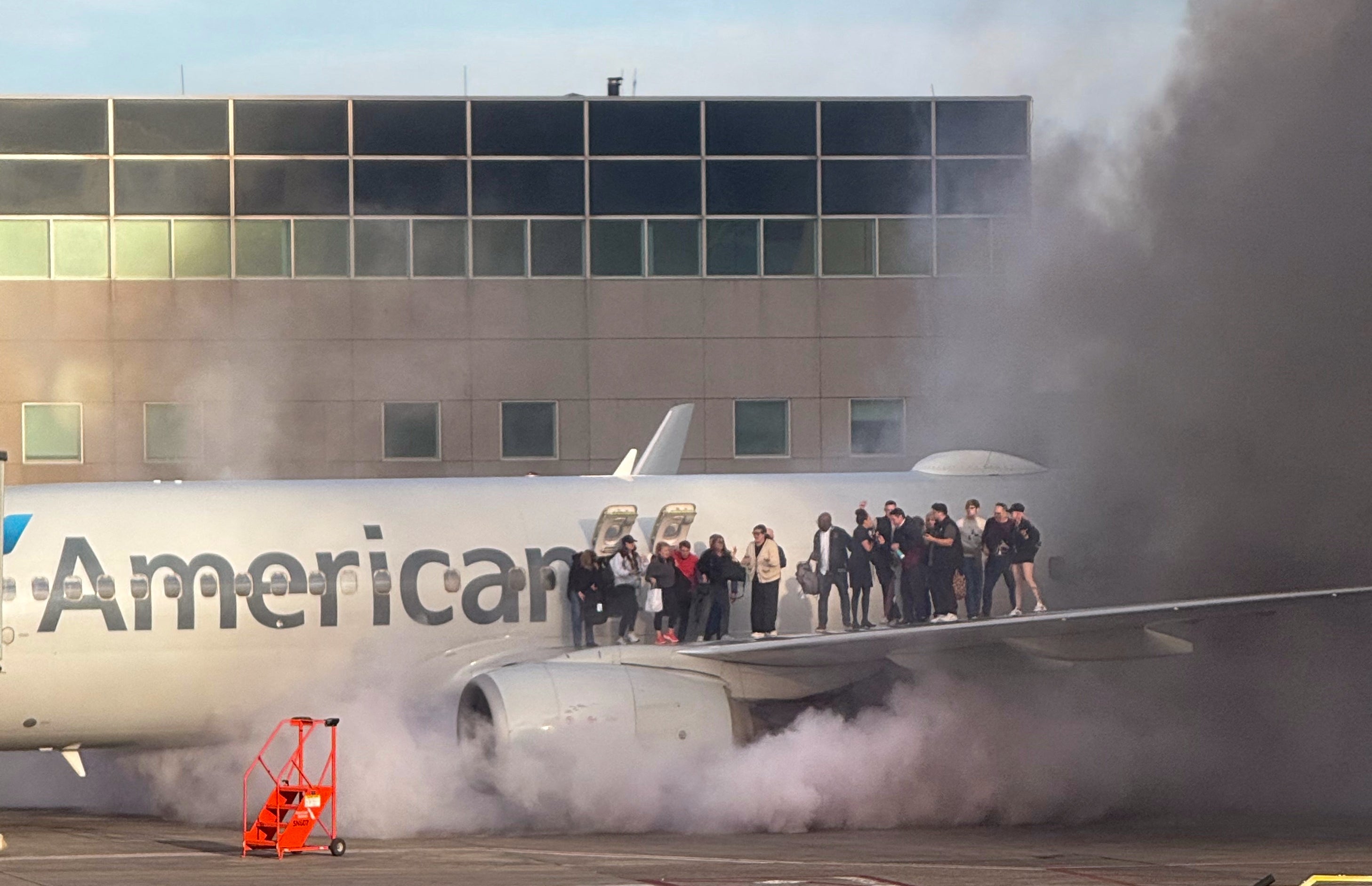 American Airlines plane catches fire on runway as passengers flee via ...