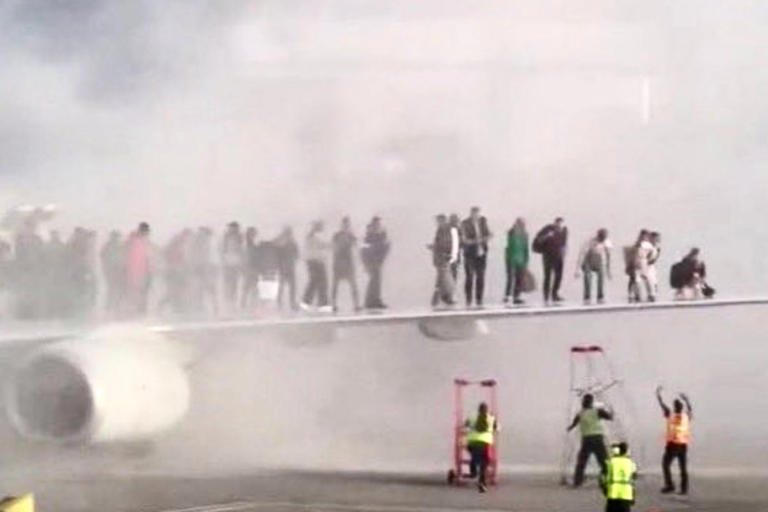 American Airlines passengers scramble onto wing to flee burning engine ...