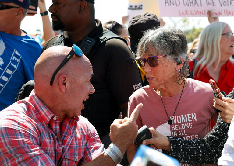 Protestors march to U.S. Rep. Brian Mast's office because of concerns ...