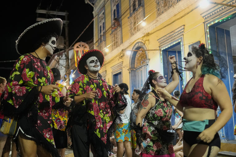 Families and revelers party side-by-side in a traditional Carnival in ...