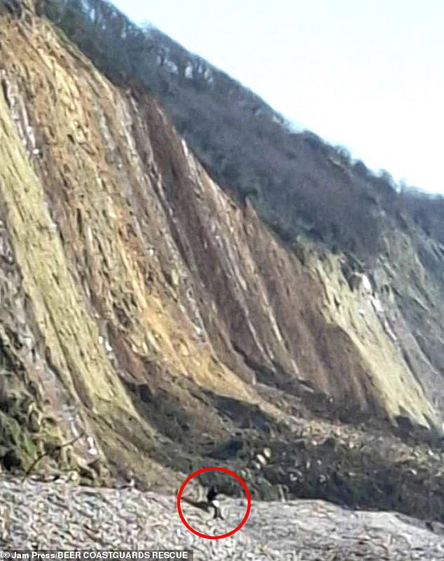 Moment dopey walker sits beneath tottering cliff after HUGE rock fall