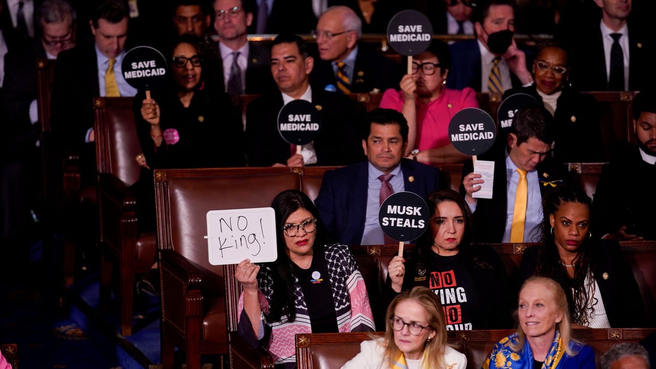 'This is not normal': Watch Democrat's sign ripped away as Trump enters