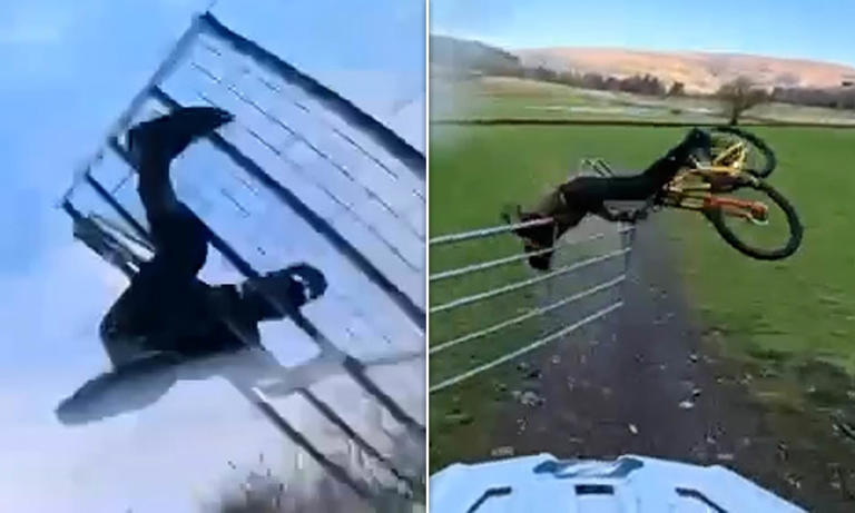 Moment mountain biker slams into gate but is miraculously unharmed