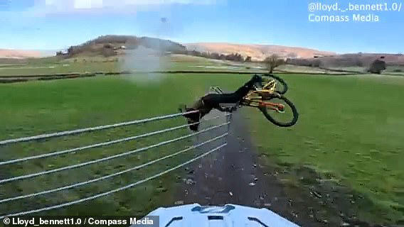 Moment mountain biker slams into gate but is miraculously unharmed