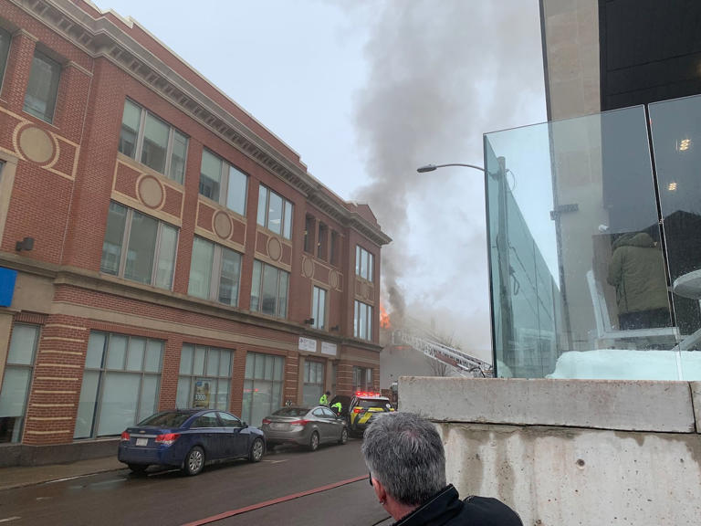 Flames shoot out of windows as apartment building burns in downtown ...