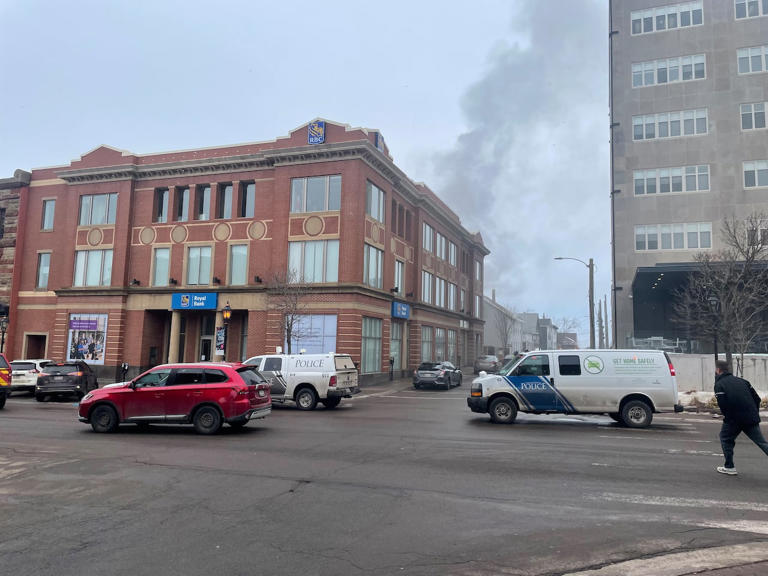 Flames shoot out of windows as apartment building burns in downtown ...