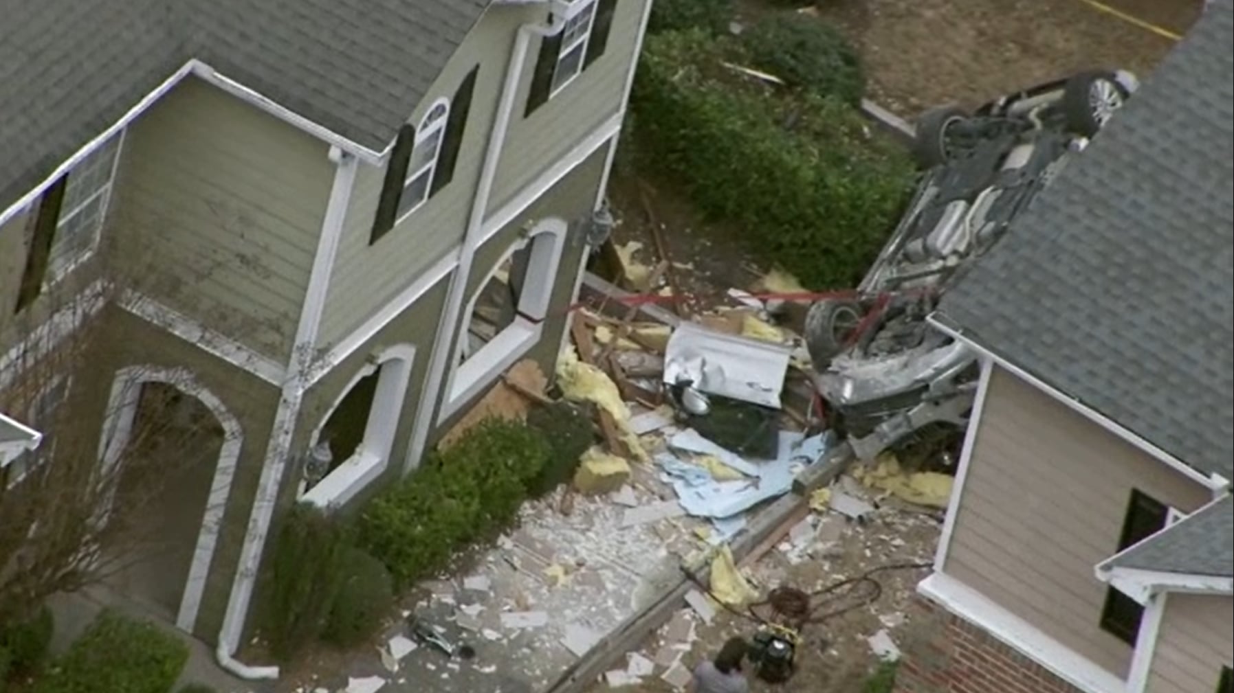Man dies after veering off road, crashing into home and down retaining wall