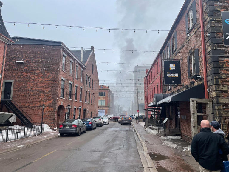 Flames shoot out of windows as apartment building burns in downtown ...