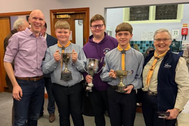 Proud head teacher praises students as they are awarded trophies at concert