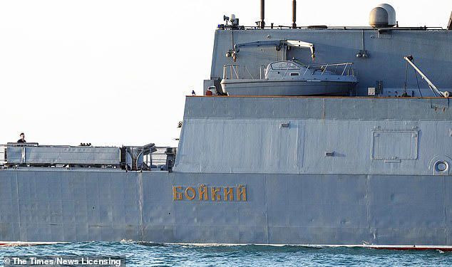 Russian officer brandishes machine gun on warship in the Channel