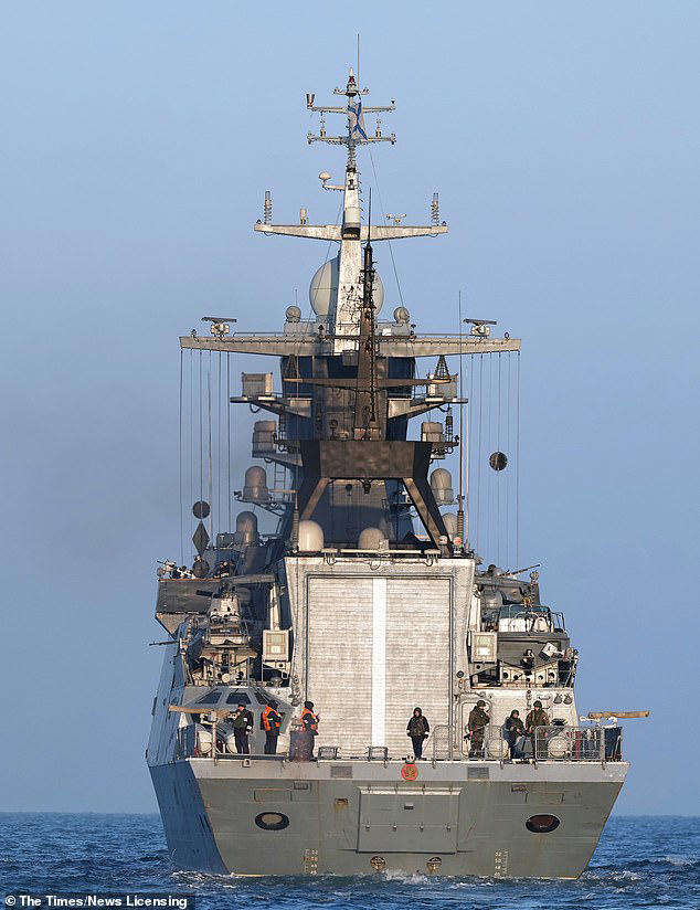 Russian officer brandishes machine gun on warship in the Channel