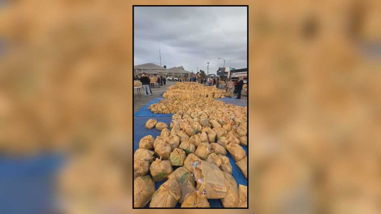 Lake City Police officials hand out food bags to hungry residents