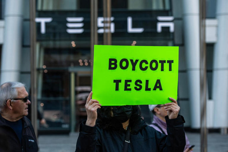 Hundreds protest Tesla showrooms over Musk’s DOGE work