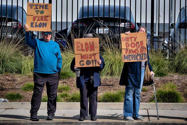 Hundreds protest Tesla showrooms over Musk’s DOGE work
