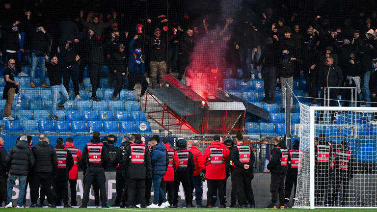 Ligue 1 game abandoned after fans throw flares, start fire in stands