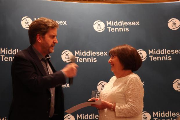 Top commentator presents award to long-serving tennis club member