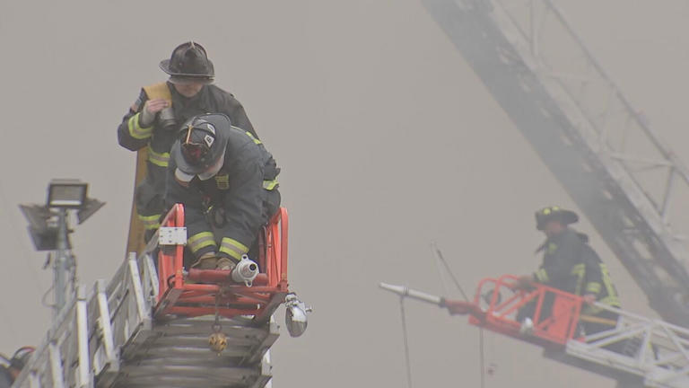 Firefighters monitoring remnants of massive blaze at waste building in ...