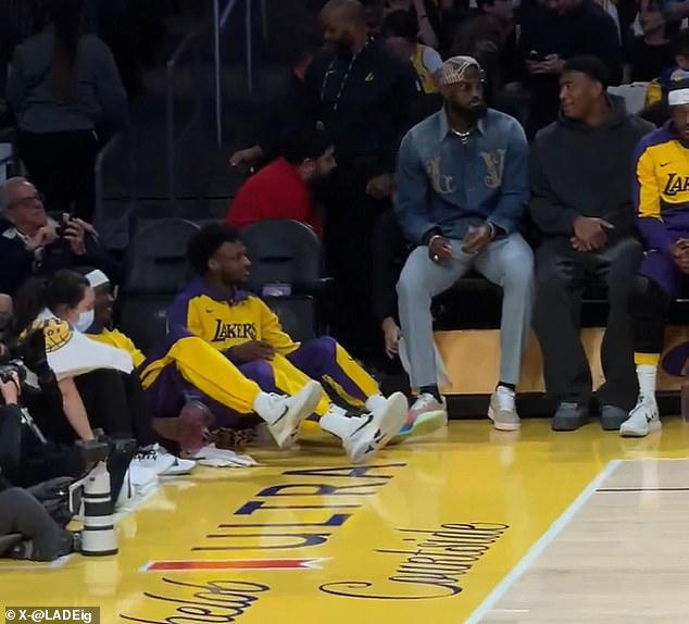 NBA fans troll Bronny James after dad LeBron forces him to sit on the FLOOR so he can take his ...