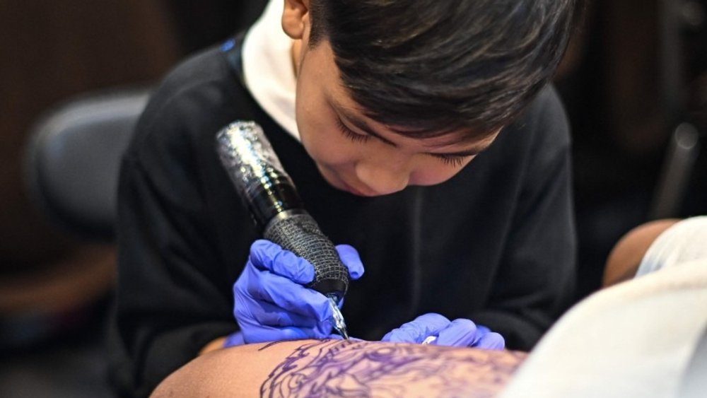 Nine-year-old boy tattoos at trade fair in Thailand