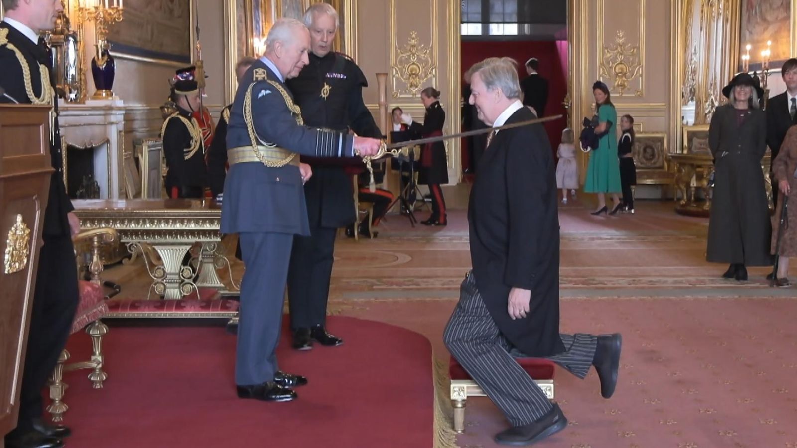 Stephen Fry knighted by King Charles
