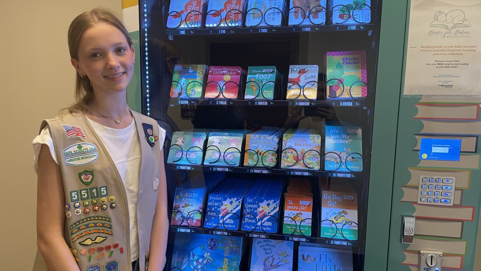 Parents insert first token into Books for Babies vending machine at ...