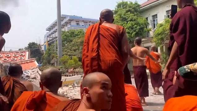 Myanmar monks watch in disbelief as tower block collapses near monastery