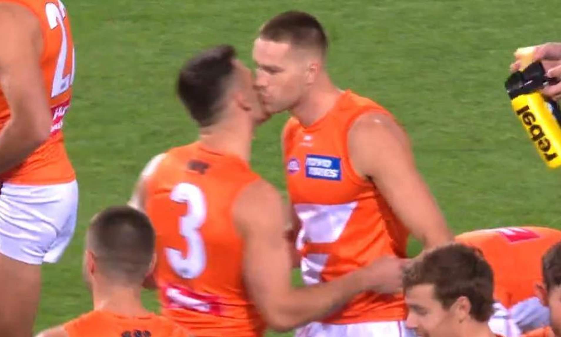 GWS Giants players share a kiss on the field before Hawthorn loss