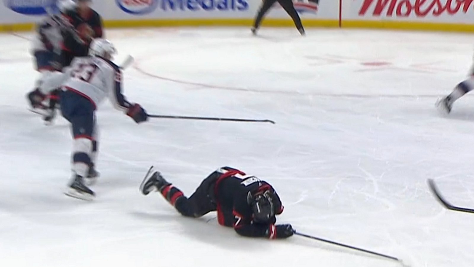 Sean Monahan rocks Brady Tkachuk with cross-check to the head.