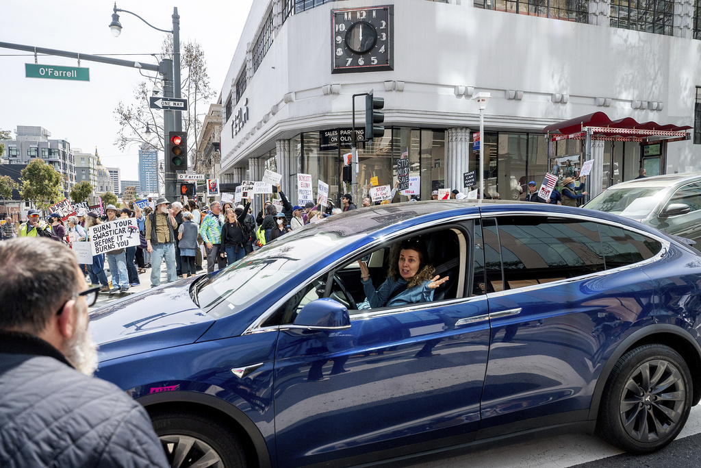 Protests against Elon Musk's purge of US government swarm Tesla showrooms