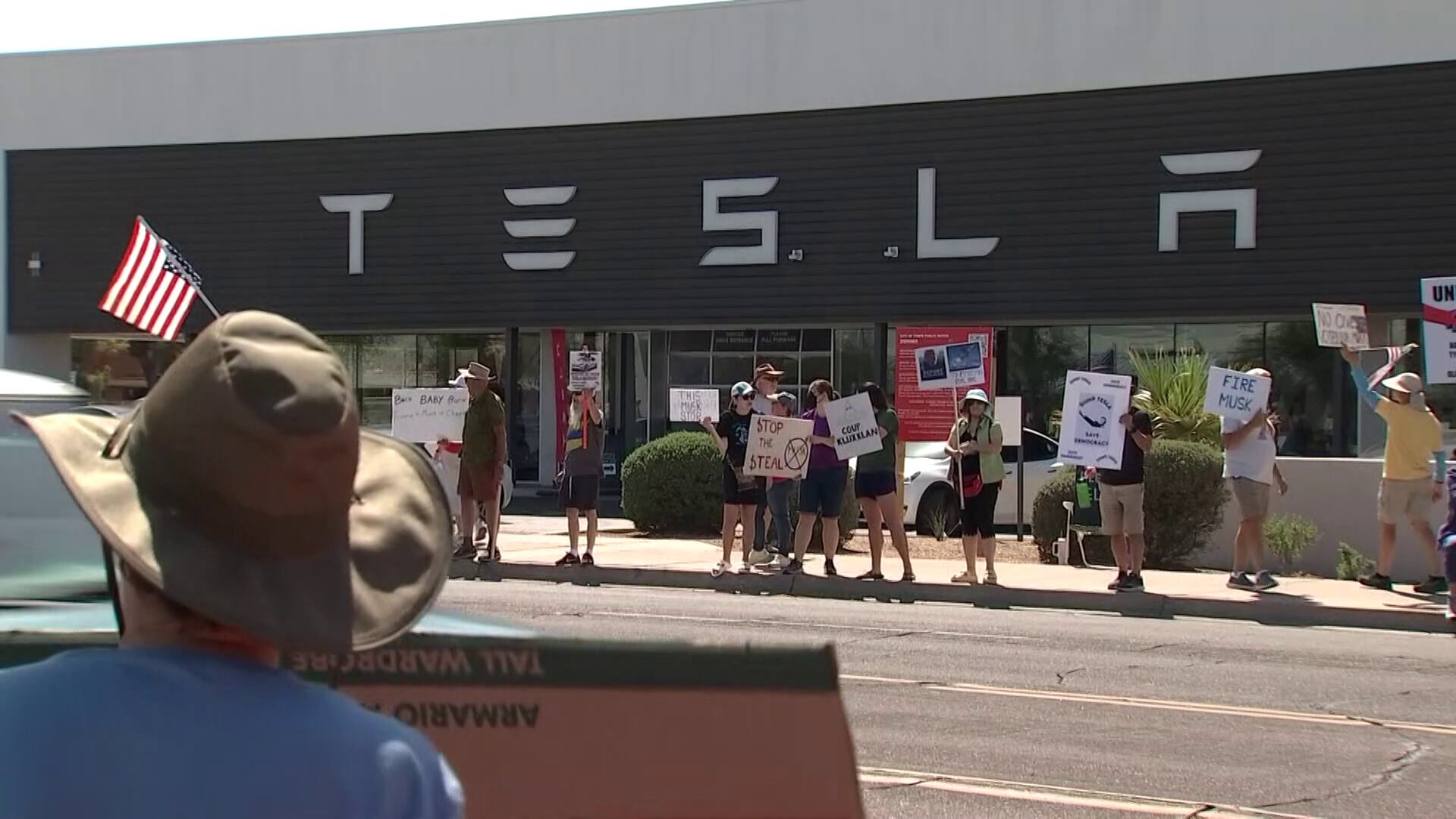 Protesters rally at Arizona Tesla dealerships against Elon Musk’s US ...