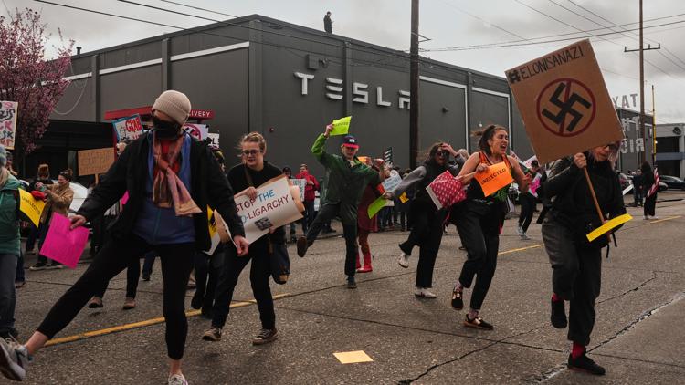 Hundreds protest outside Seattle-area Tesla dealerships as part of ...